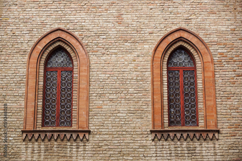 Castle window in a medieval style. Double arched window on a facade of ...