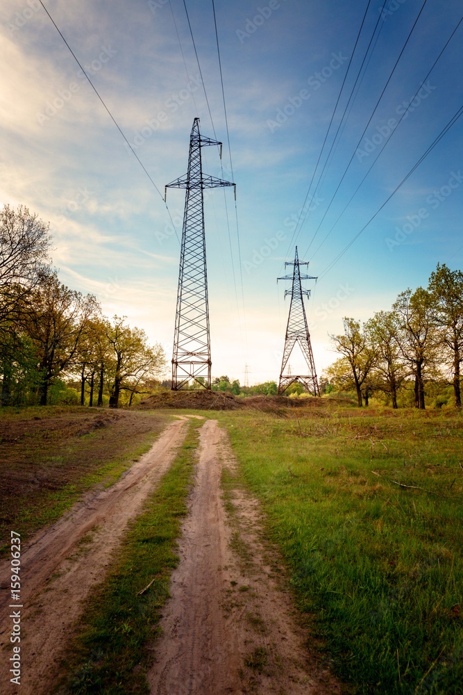 Country road under the electric transmission line in summer. Stock ...