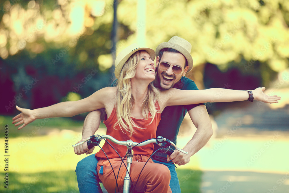 Happy Couple Riding a Bike Stock Photo | Adobe Stock