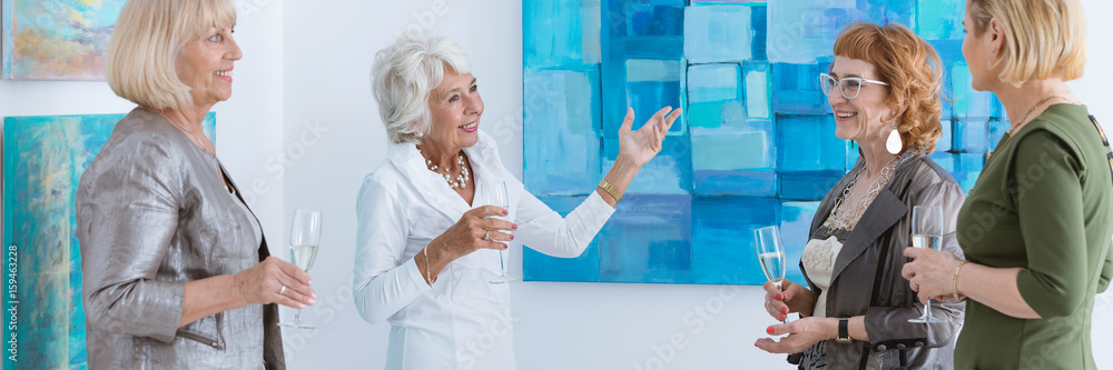 Women discussing painting Stock-Foto | Adobe Stock