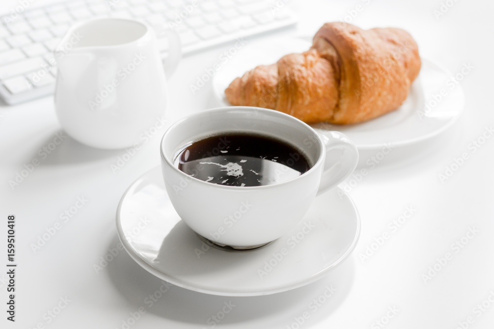 Office lunch with coffee and croissant, keyboard on white table ...