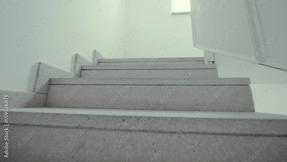 Climbing the white stairs. Someone step by step climbs the steps POV ...