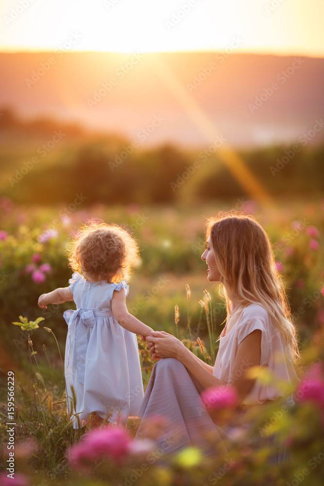 Beautiful child girl with young happy mother are wearing casual clothes ...