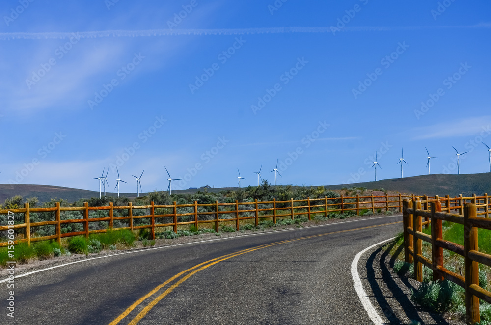 Fotka „Entrance of a wind farm with the asphalt road leads to ...