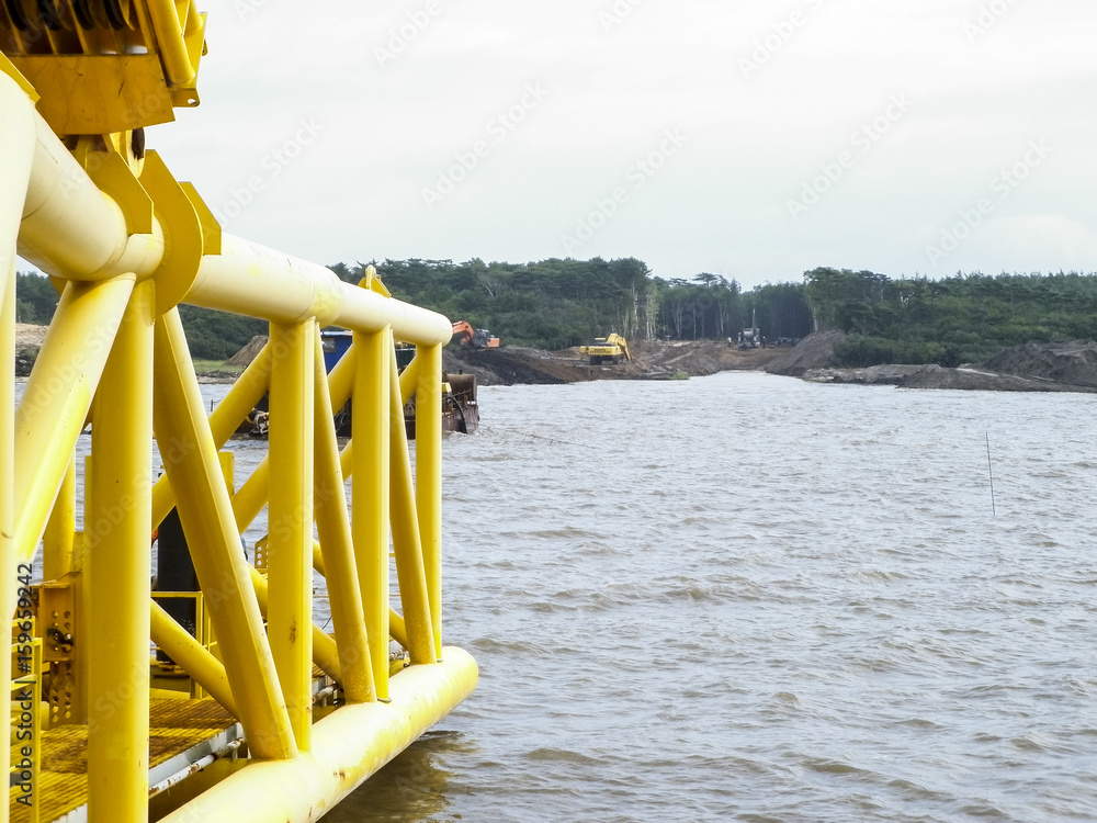 Laying of pipes with pipe-laying barge crane near the shore. Descent of ...