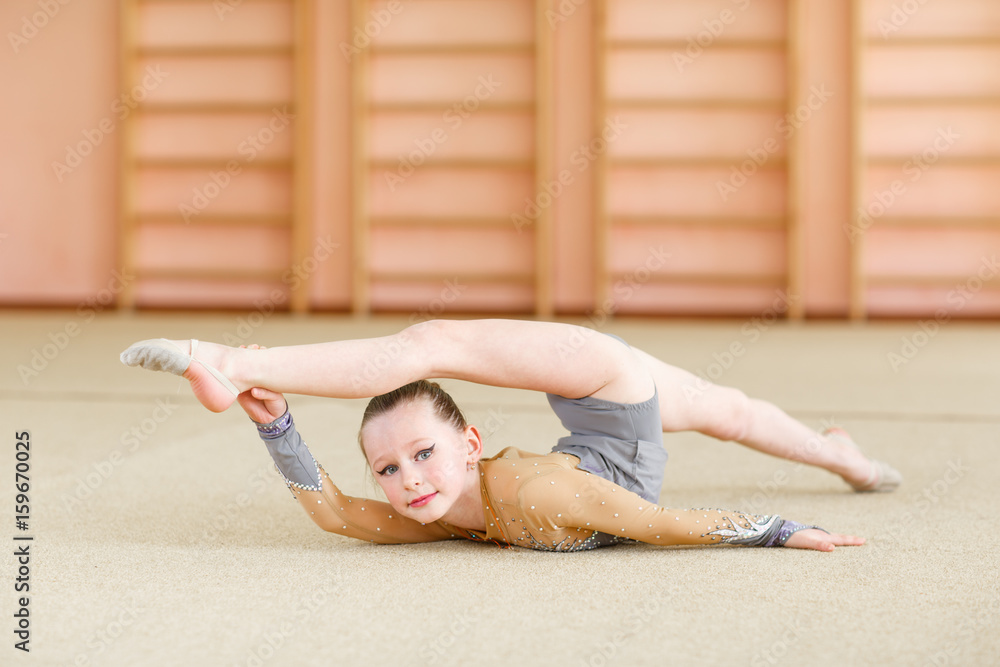 Young girl doing gymnastics. Stock Photo | Adobe Stock
