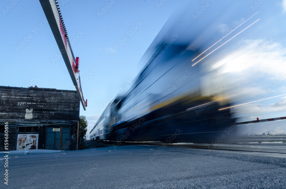 fast blur of train next to safety arm and building Stock-Foto | Adobe Stock