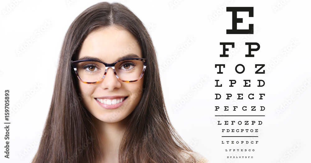 smile female face with spectacles on eyesight test chart background ...