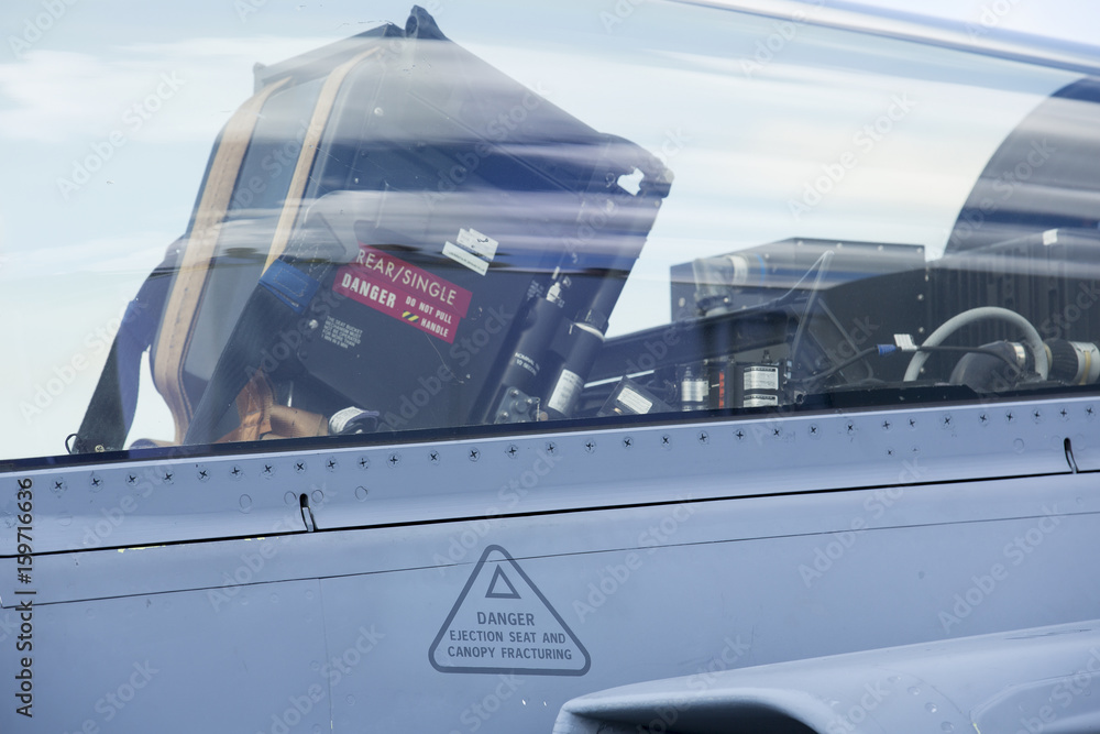 Cockpit of a tactical jet fighter with seat and instructions how to ...