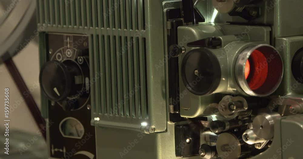 movie projector in operation, showing a film - lamphouse, lens and ...