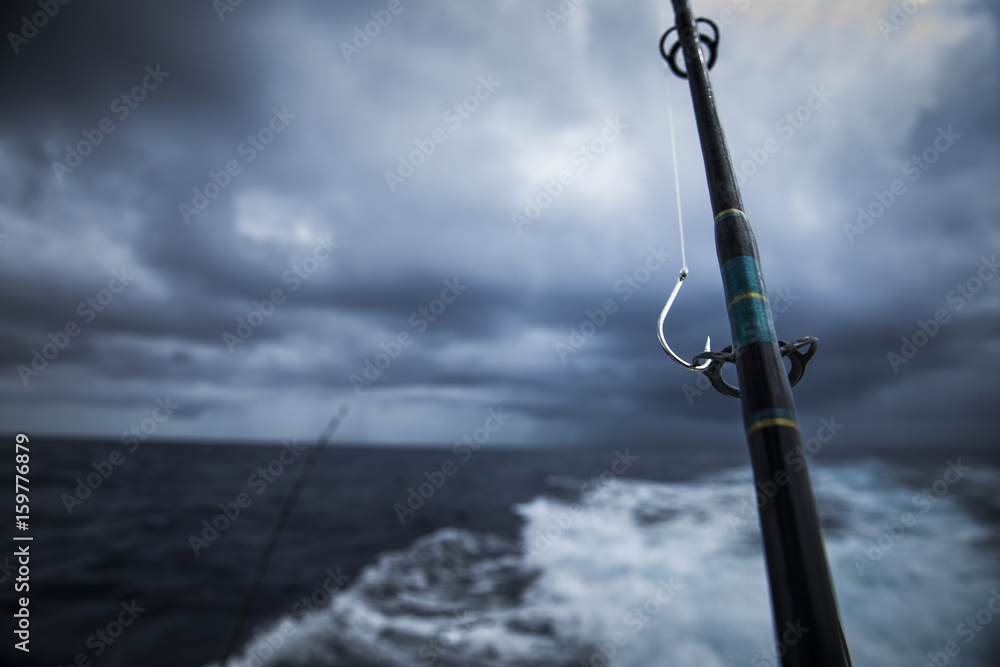 Deep sea fishing pole with a stormy sea and sky. Stock Photo | Adobe Stock
