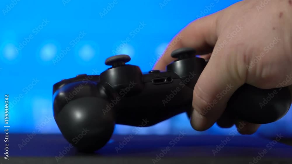 Gamer playing game on video gaming console with wireless controller ...