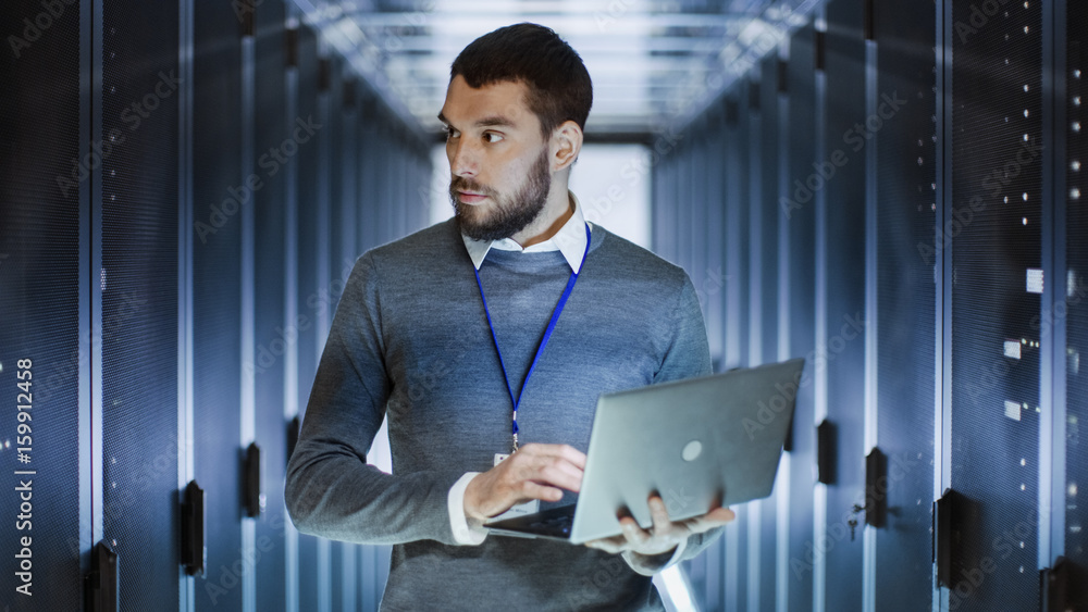 Male IT Specialist Holds Laptop and Discusses Work with Female Server ...