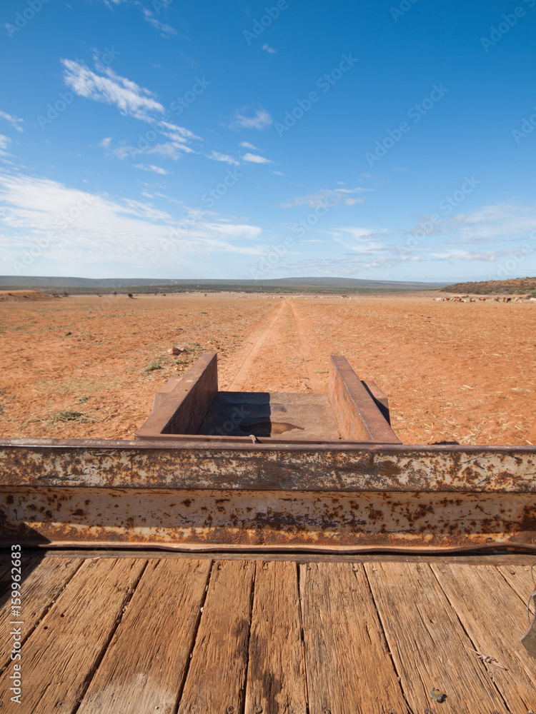 Rusty old Australian cattle truck driving in a sun drenched arid ...