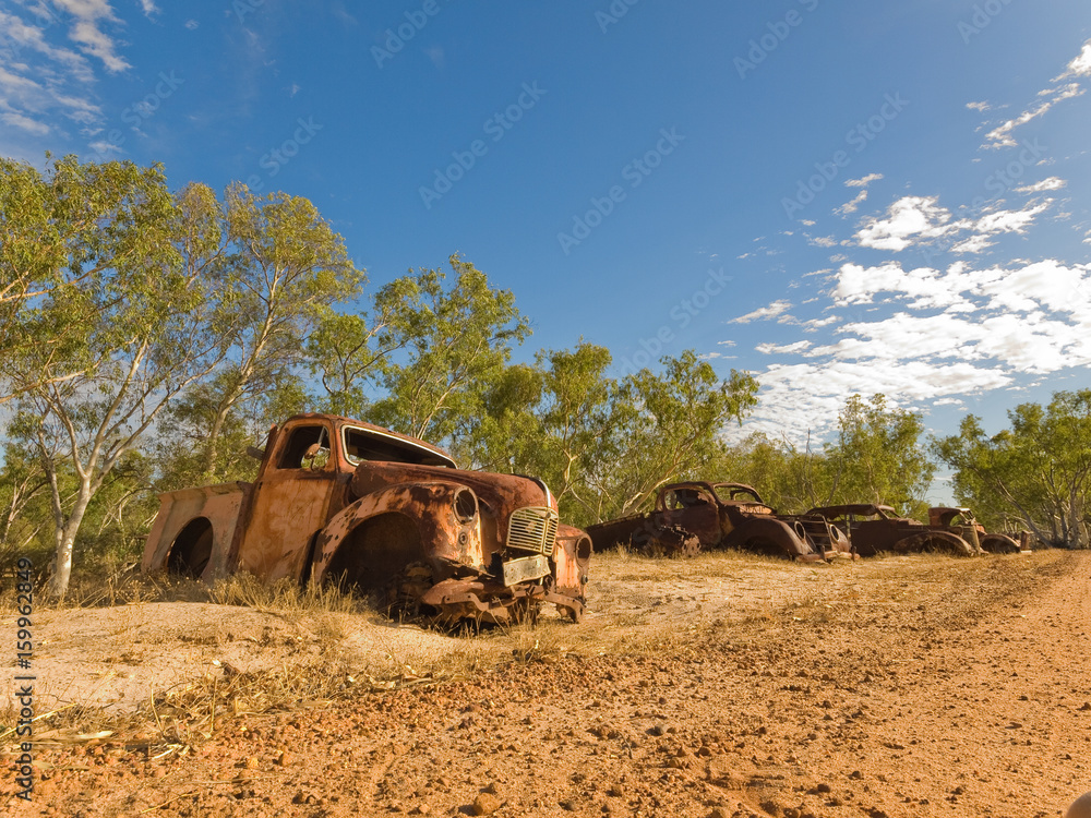 Rusty old australian vehicles in a sun drenched arid landscape. A car ...