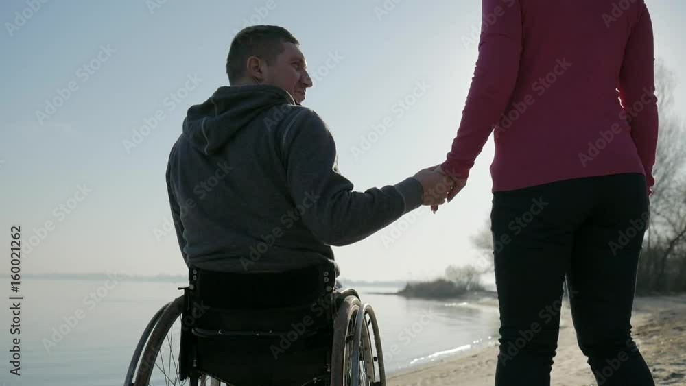 invalid love, handicapped gives hand to girlfriend, back view, cripple ...