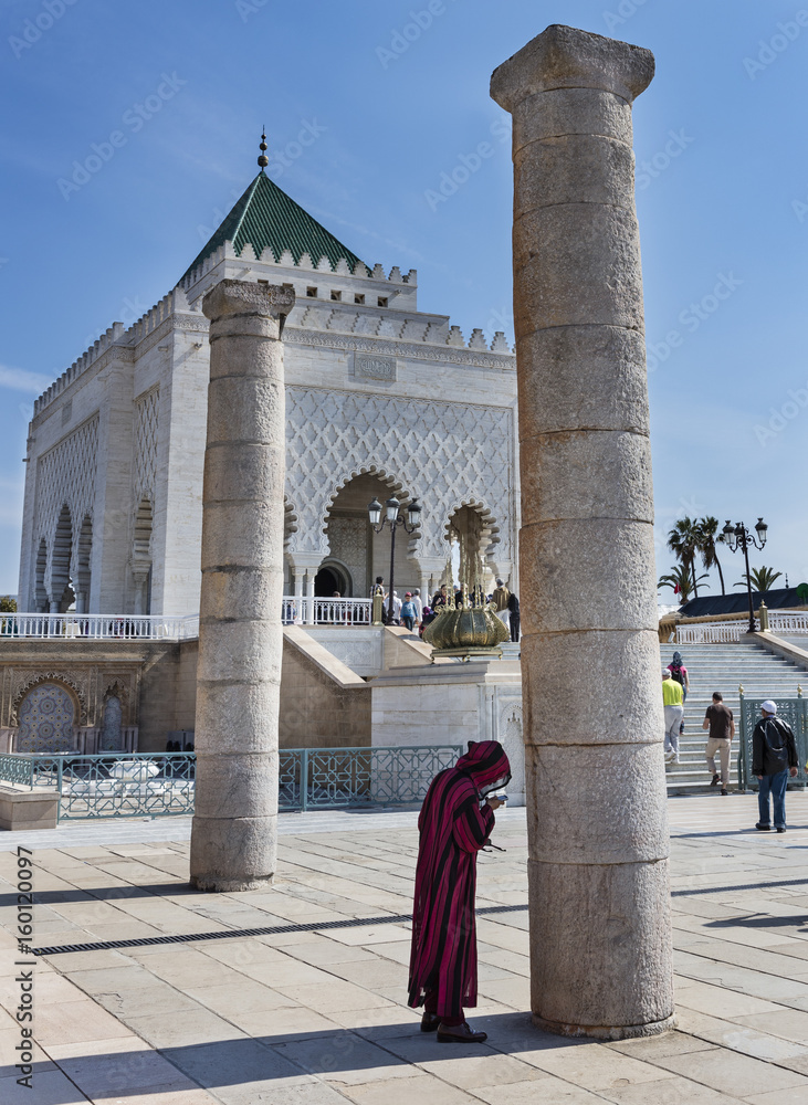 Muslim resting (praying) in the shade of column in front of Mausoleum ...