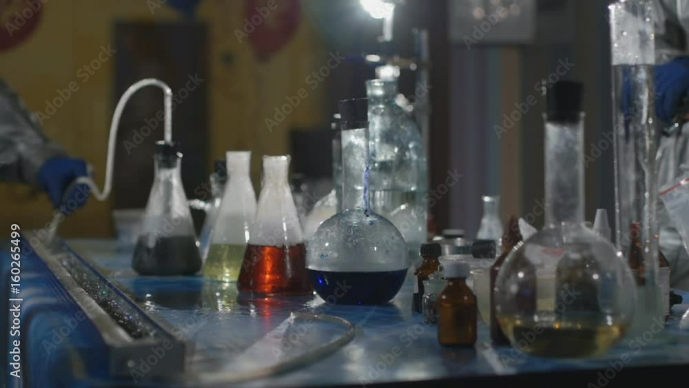 The scientist and his assistant conduct chemical experiments in an ...