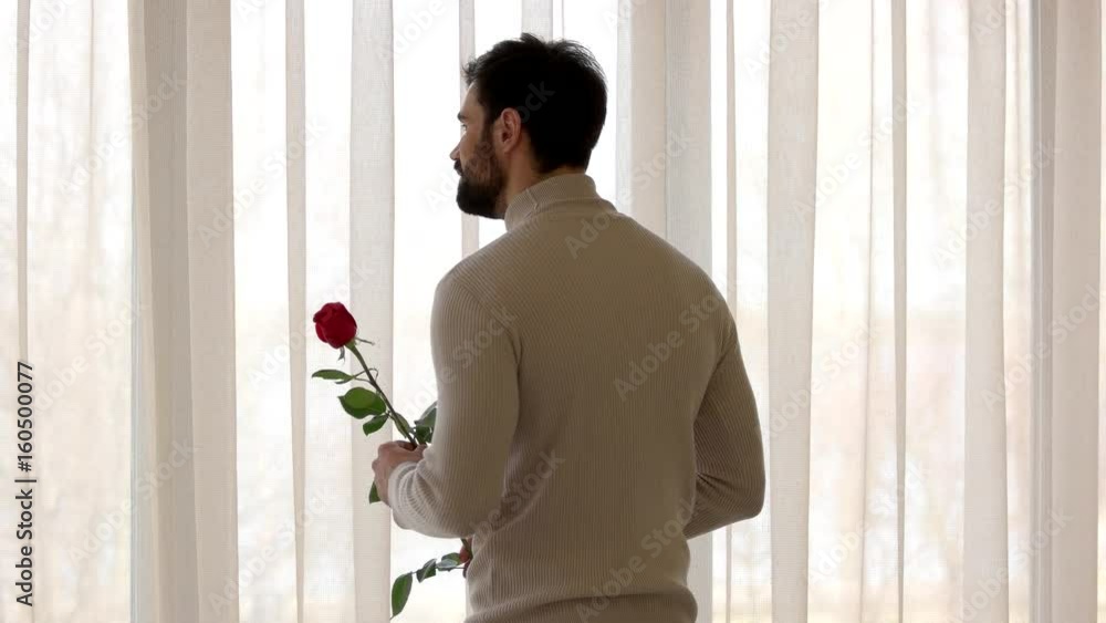 Bearded man holding rose. Guy near window. Love and wait. Stock Video ...