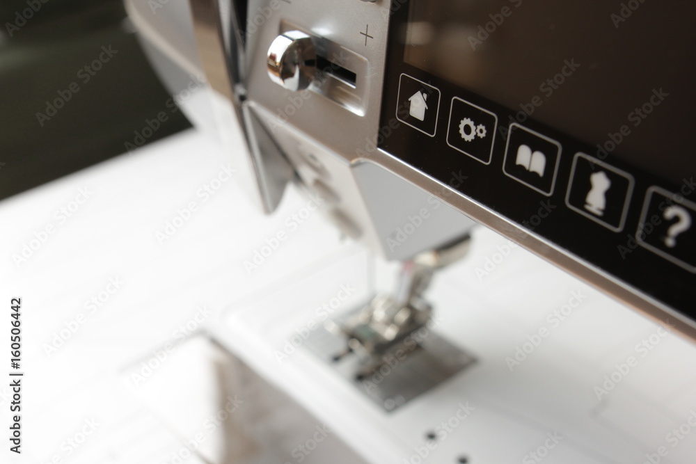 control buttons and touchscreen of a modern computerised sewing machine ...
