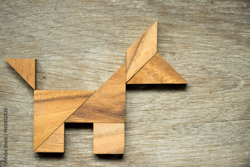 Tangram puzzle in dog shape on wooden background Stock Photo | Adobe Stock