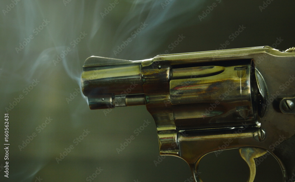 revolver gun with smoke floating in the air after shoot on black ...