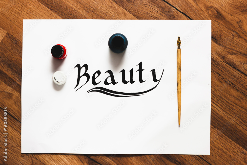Calligraphy Beauty word background. Equipment and letters made with ink ...