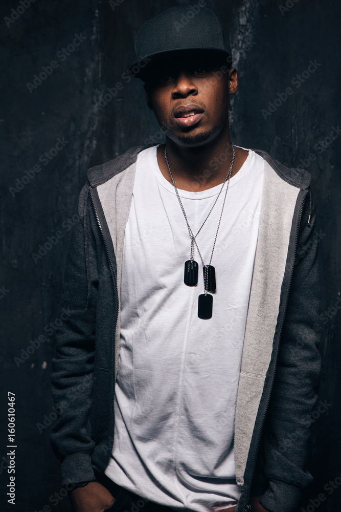Dangerous unhappy black man stay on dark background. American gangster ...