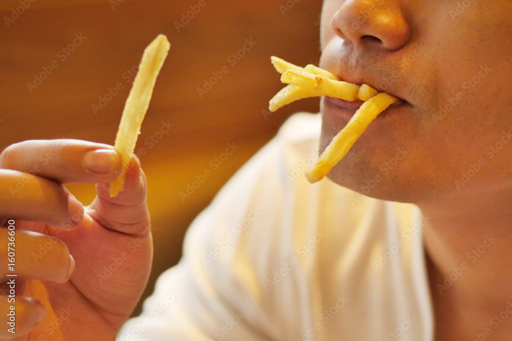 man eating french fries, fried potato, chip, unhealthy junk fast food ...
