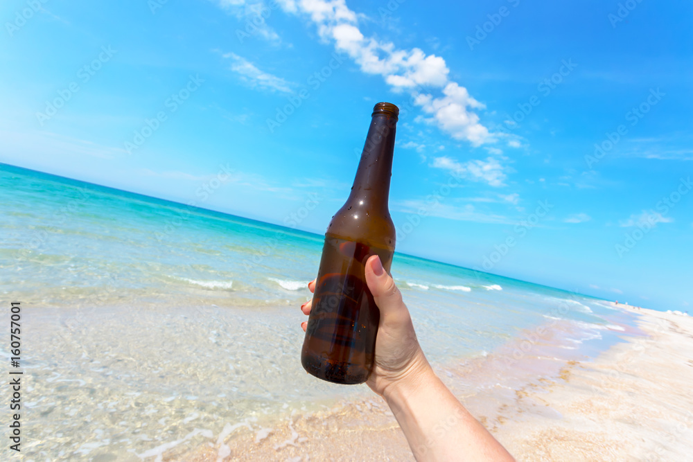 Beer bottle on a sandy beach Stock Photo | Adobe Stock