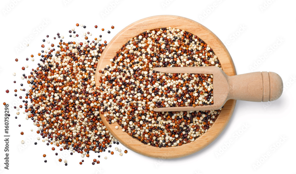 dried quinoa in the wooden plate and shovel on the white background ...