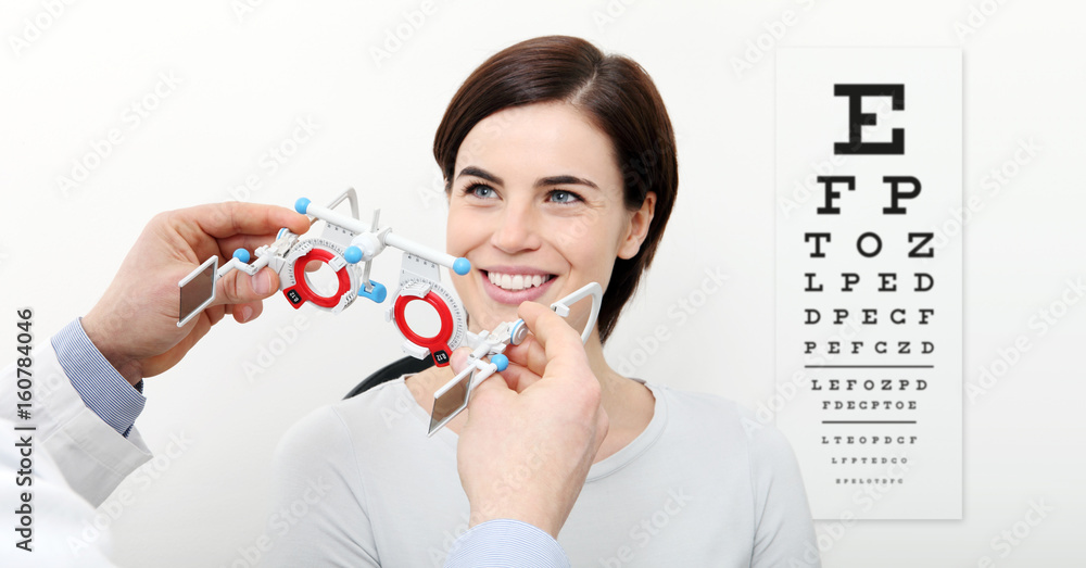 smile woman doing eyesight measurement with trial frame and visual test ...