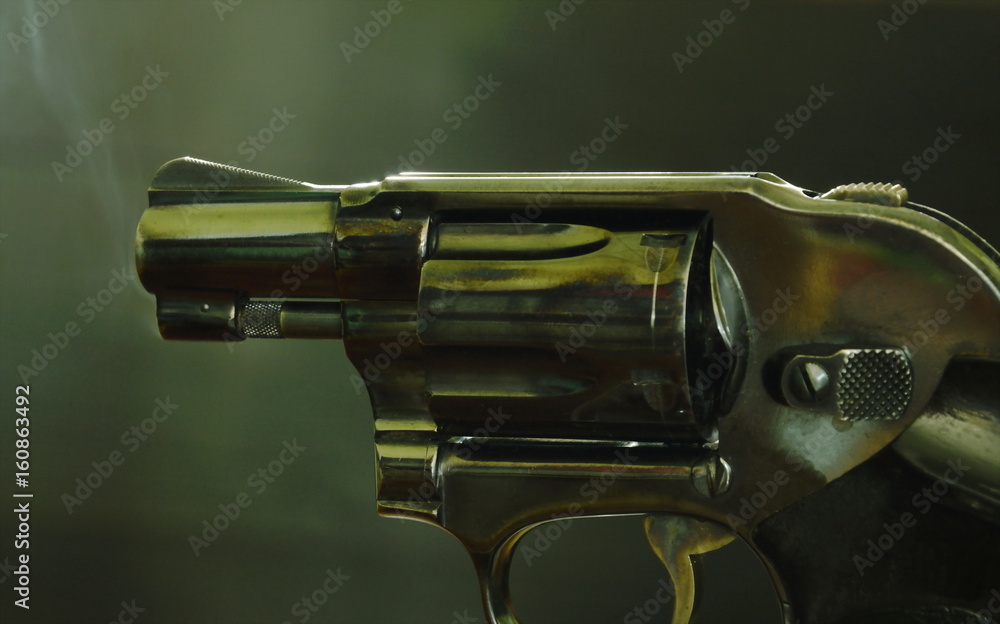 revolver gun with smoke floating in the air after shoot on black ...