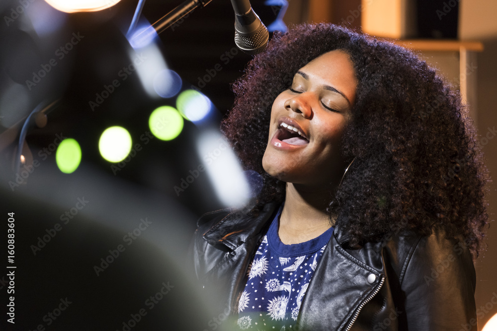 Black female singing in a recording studio Stock Photo | Adobe Stock