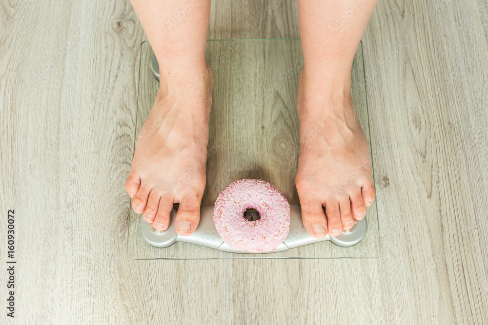 Diet Concept. Close-up of Woman's feet On Weighing Scale With Donut ...