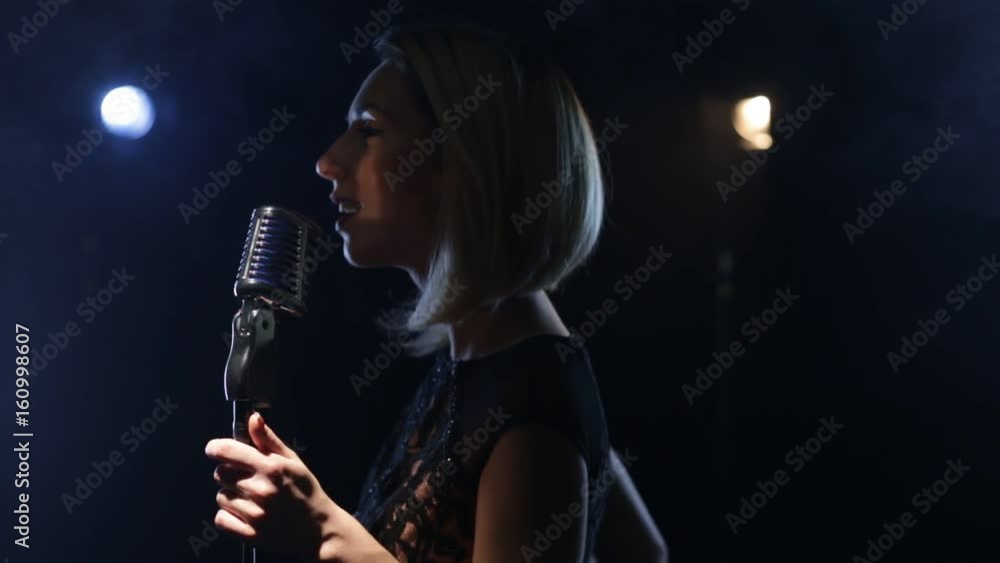 Woman with retro style microphone Stock Video | Adobe Stock