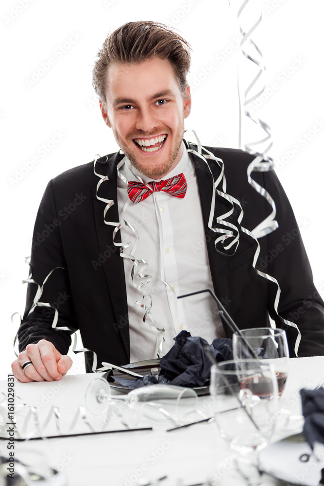 Crazy looking party guy wearing a black suit and red bow tie sitting ...
