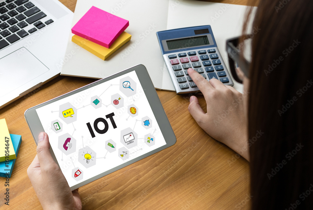 IOT business man hand working and internet of things (IoT) word diagram ...