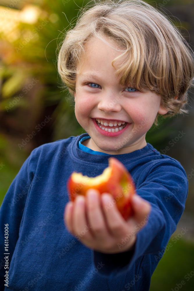 cute 5 year old child eating an apple Stock Photo | Adobe Stock