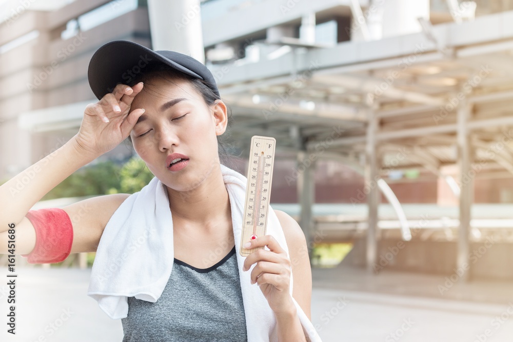 High temperature made sporty woman feeling heat stroke in Summer season ...