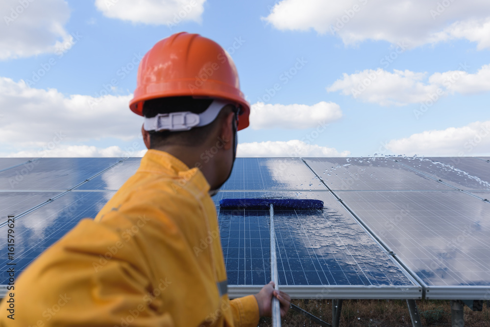 Workers or engineers are cleaning cleaning photovoltaic panels in the ...