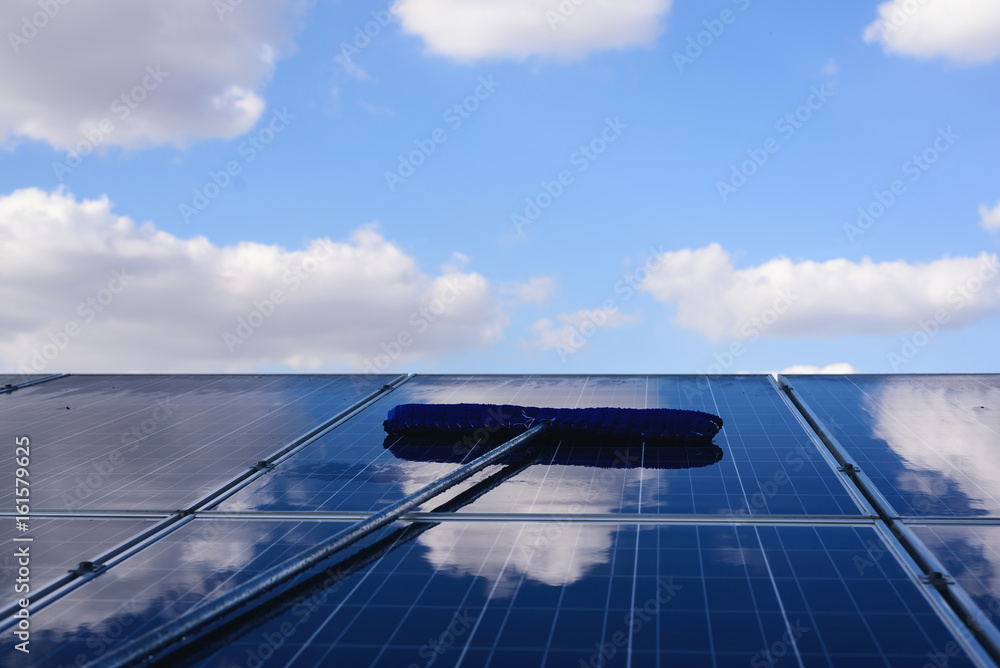 Workers or engineers are cleaning cleaning photovoltaic panels in the ...