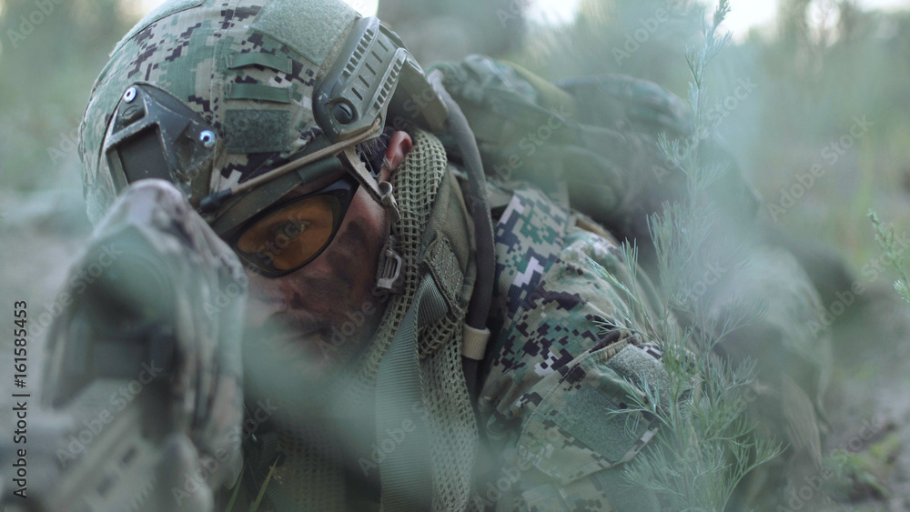 Soldier lying with sniper rifle on battlefield and aiming. Stock Photo ...