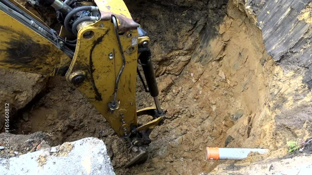 Tractor excavator digging the pit with a big scoop. Construction ...