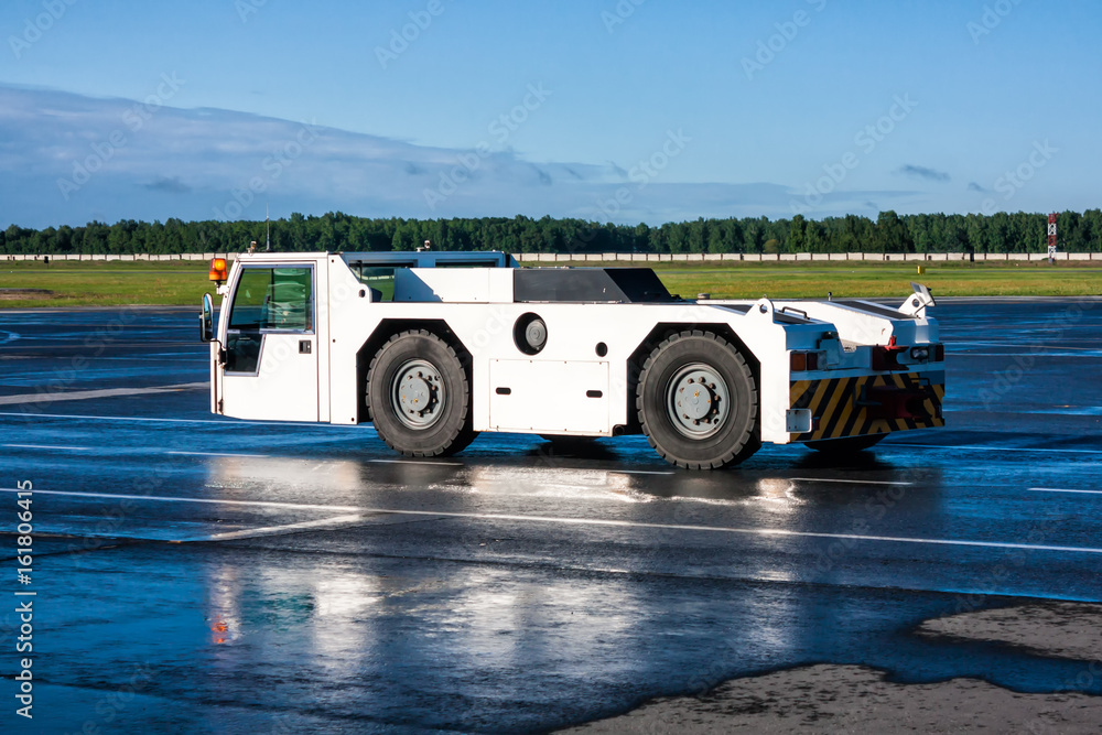 Airplane tow tractor at the airport apron Stock Photo | Adobe Stock