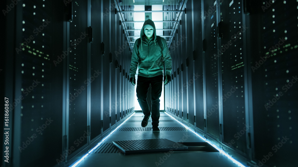 Hooded Hacker in a Mask Walks Through Working Data Center with Open ...