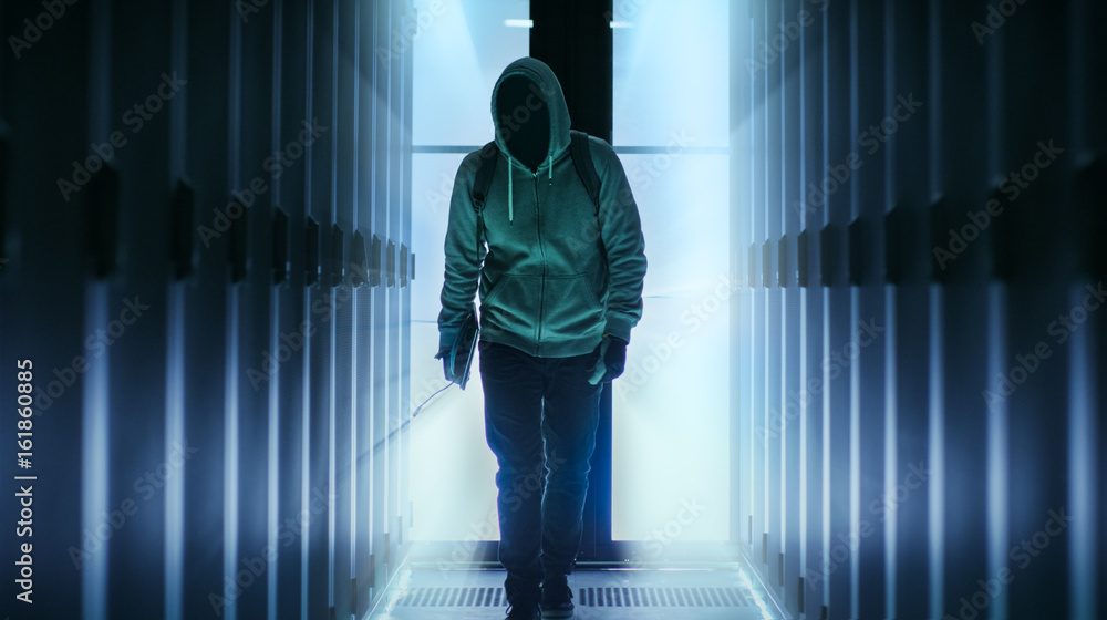 Hacker With a Hidden Face Wearing Hoodie Walks in Through Data Center ...