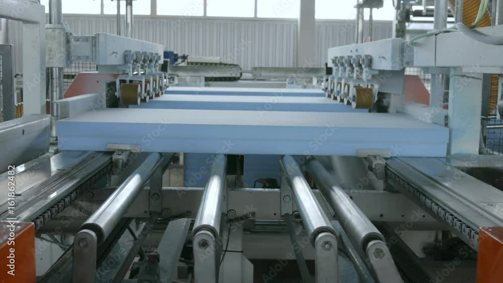Polystyrene styrofoam in processing, foam plastic on conveyor line ...