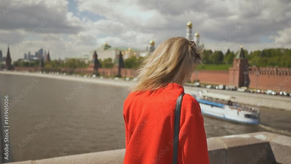 The blonde girl is happy to be in Moscow. The girl is pleased with the ...