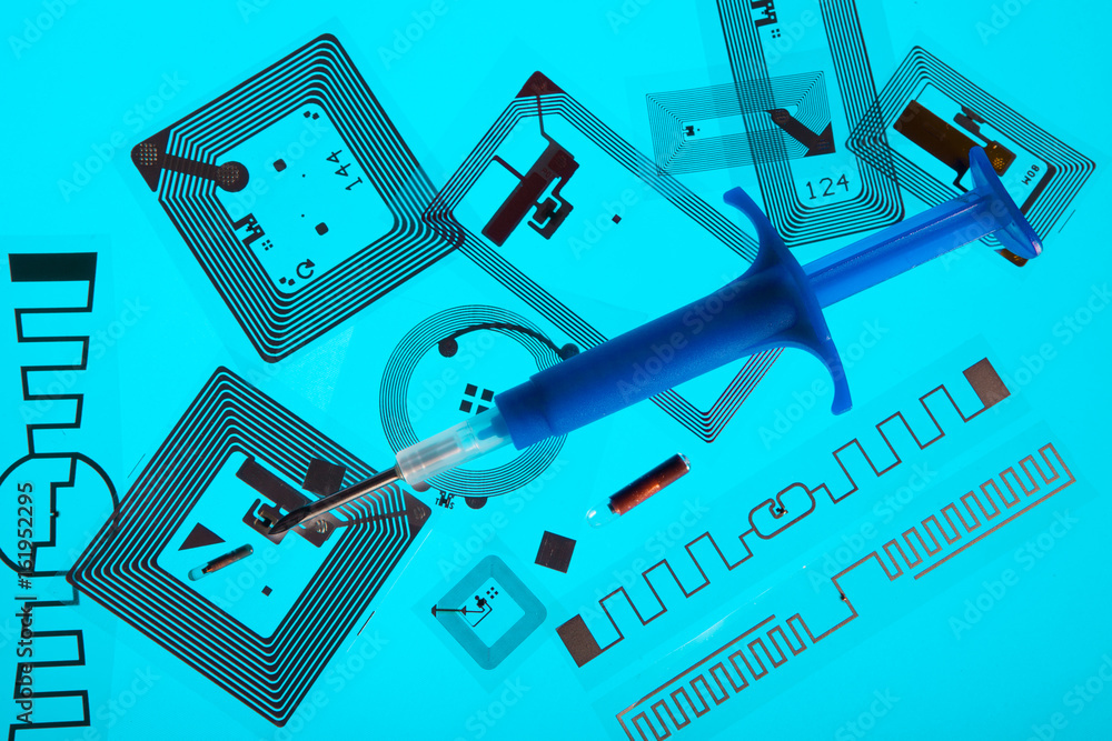 RFID implantation syringe and chips on RFID tags (Radio Frequency ...